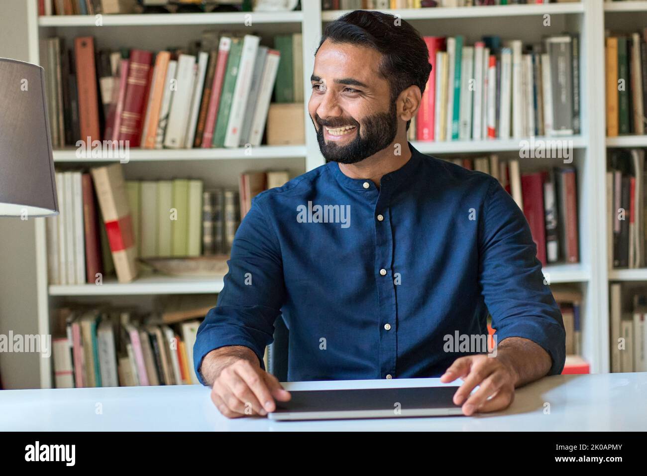 Happy smiling indian ethnic business man sitting at work desk with ...