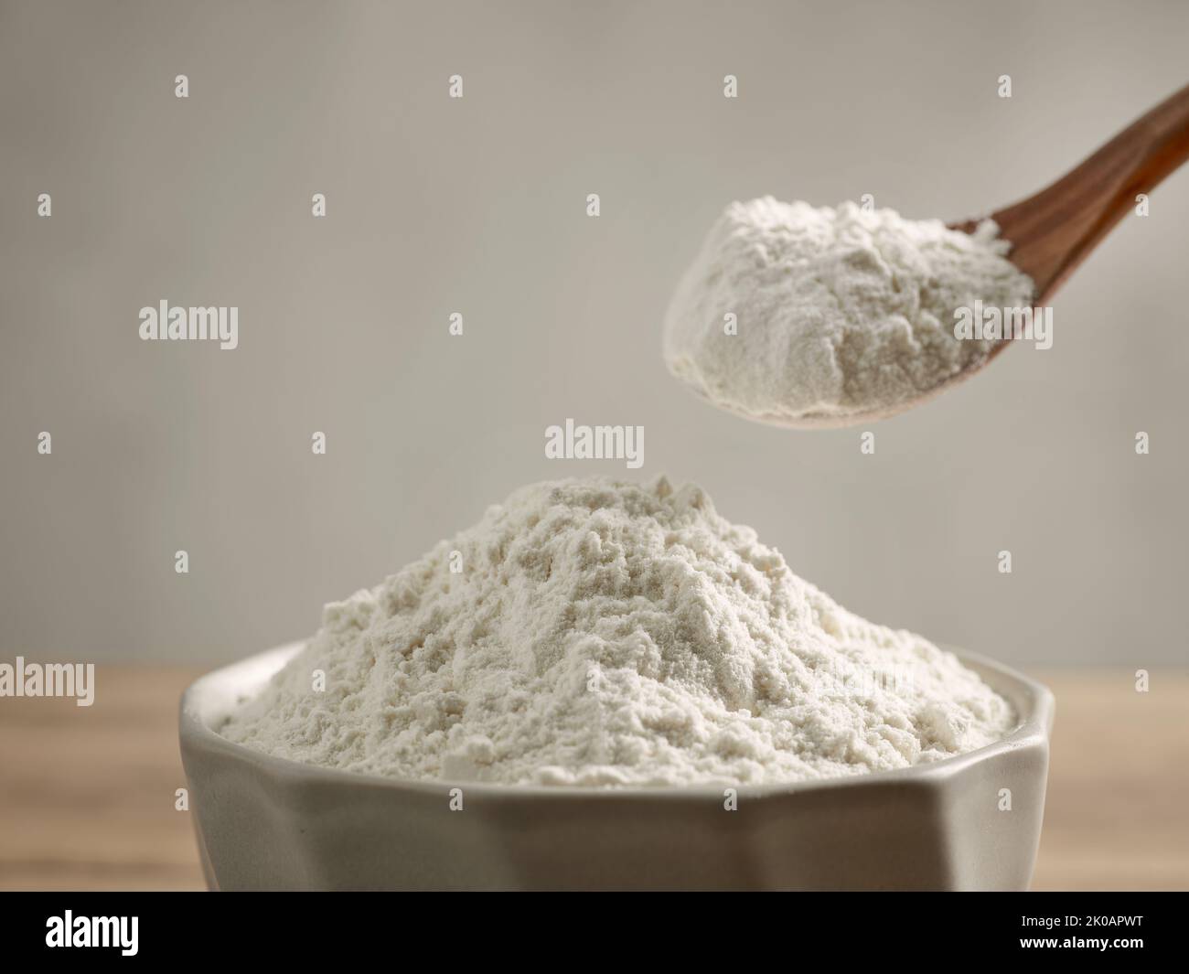 bowl and spoon of flour on pastel color background Stock Photo - Alamy