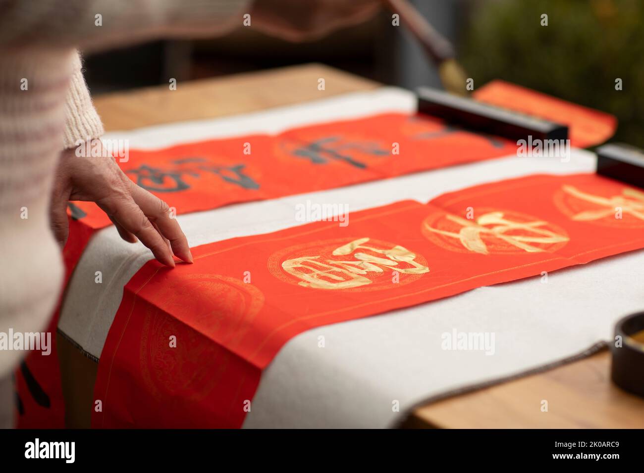 Happy senior Chinese man writing calligraphy on couplets Stock Photo ...