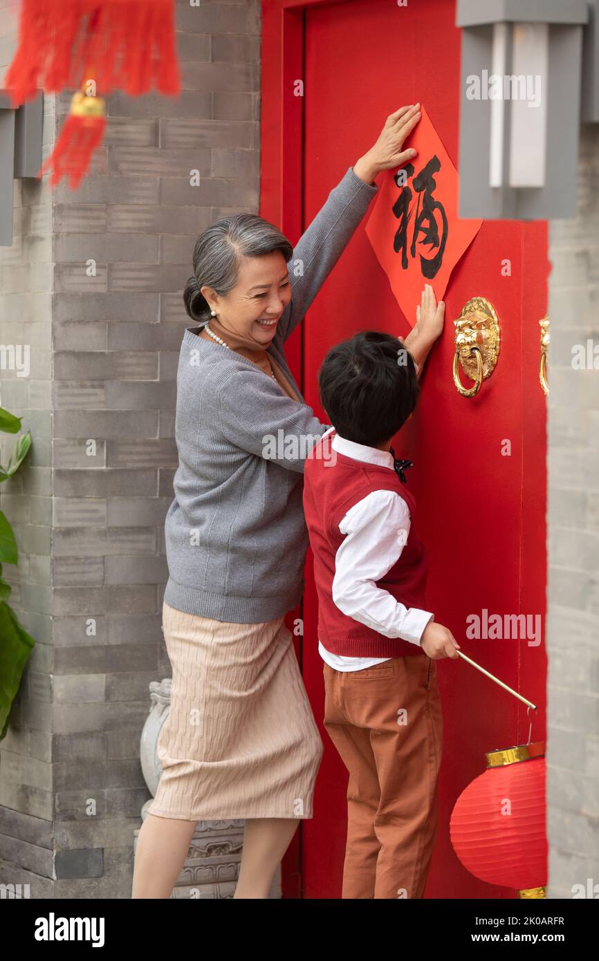 Happy grandmother and grandson celebrating Chinese New Year Stock Photo ...
