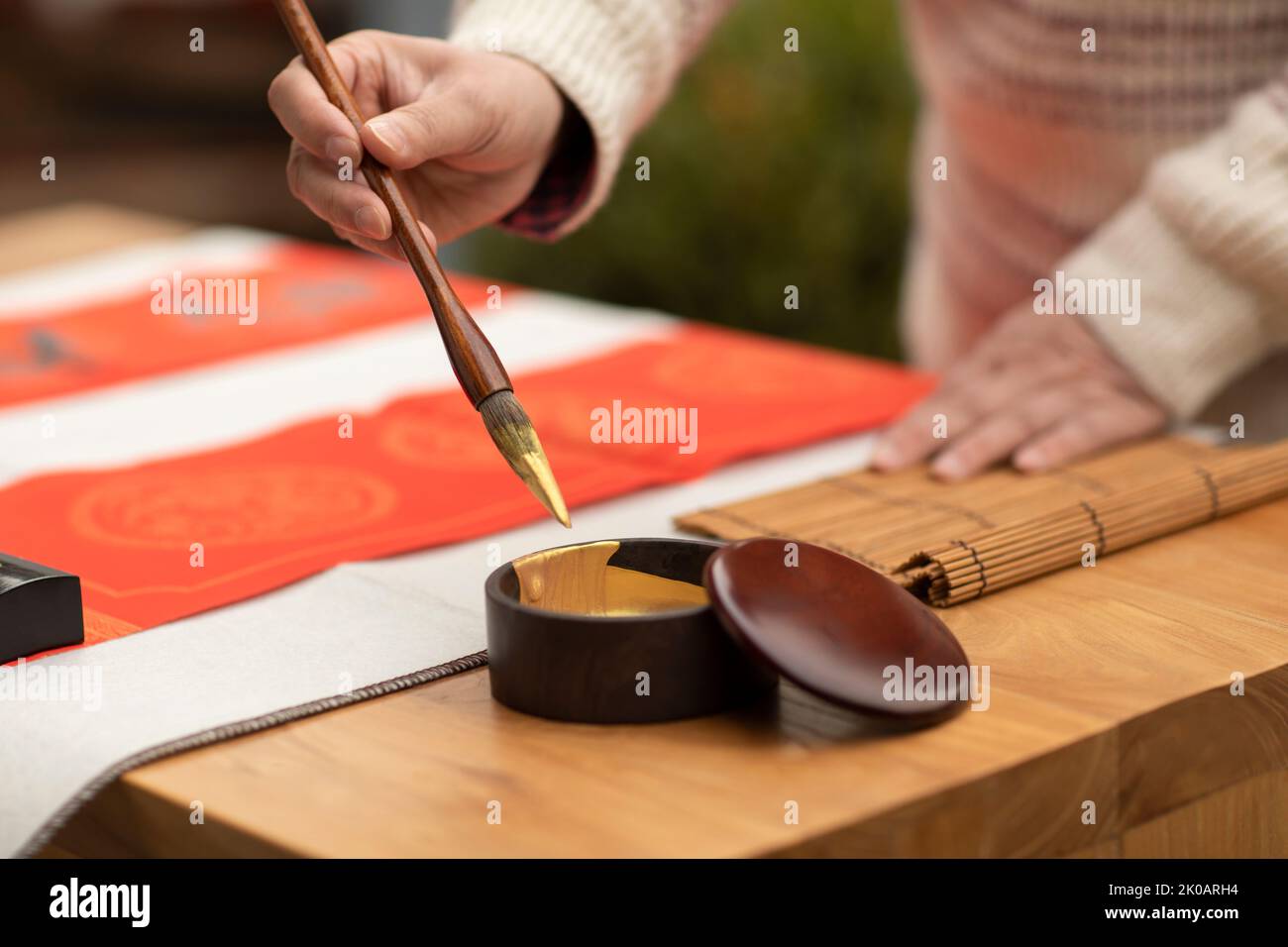 Happy senior Chinese man writing calligraphy on couplets Stock Photo ...