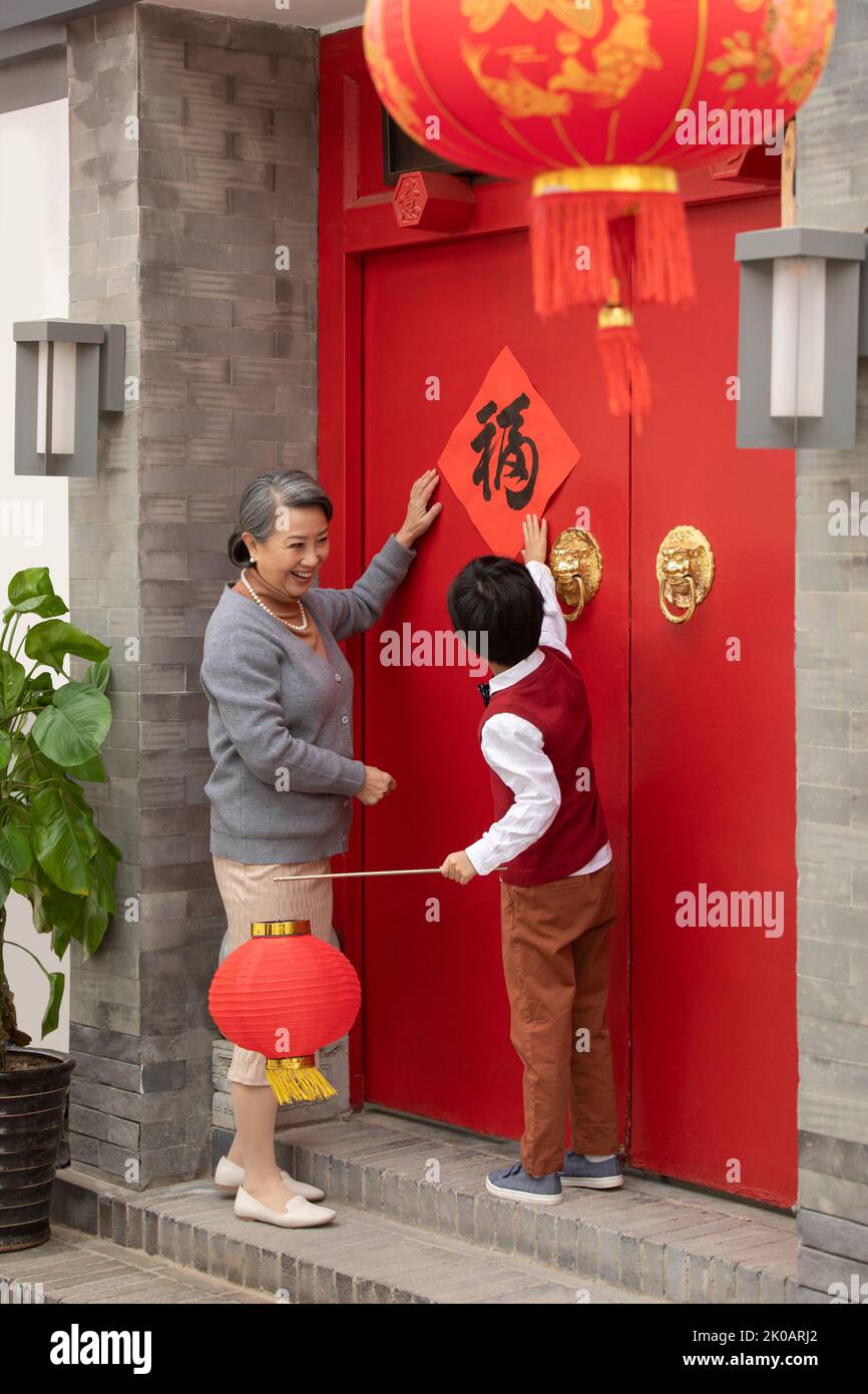 Happy grandmother and grandson celebrating Chinese New Year Stock Photo ...