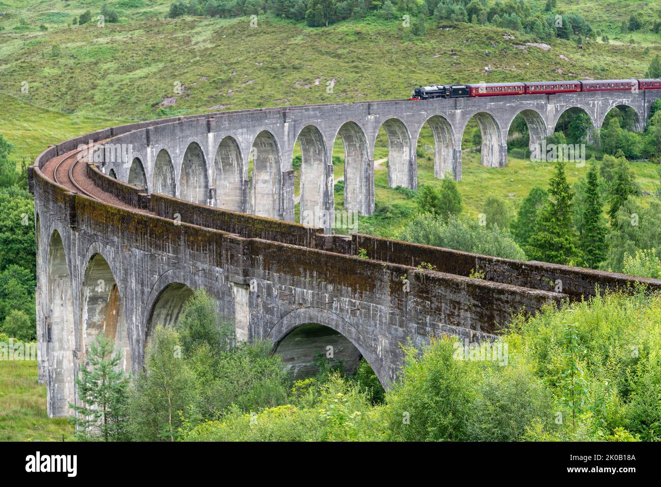 The Jacobite steam locomotive,tourist train,starts to cross the iconic ...