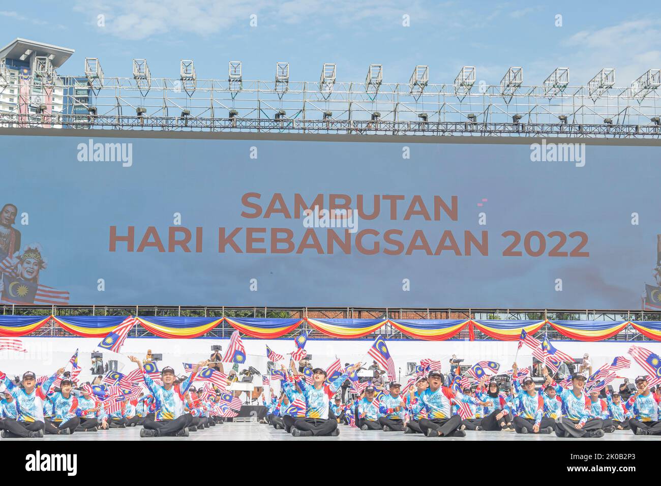 Malaysian dance performers waving Malaysia's flags during rehearsal ...