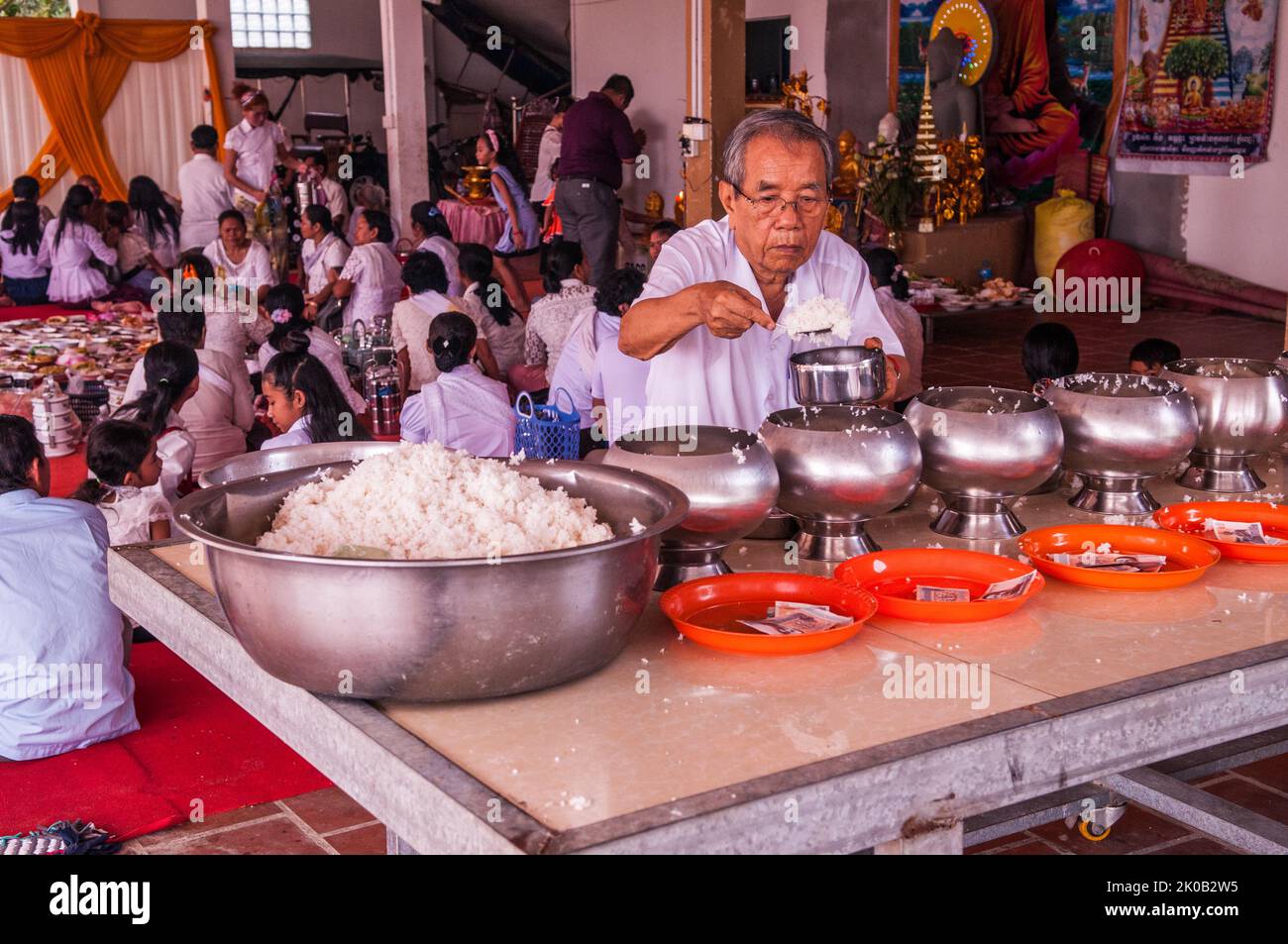 Kandal province, Cambodia. A Cambodian Buddhist man donates rice ...