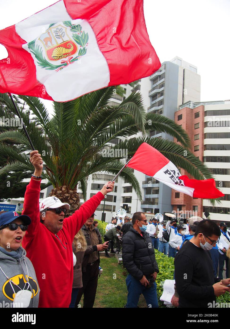 A man waving two Peruvian flags when hundreds gather in the streets to ...