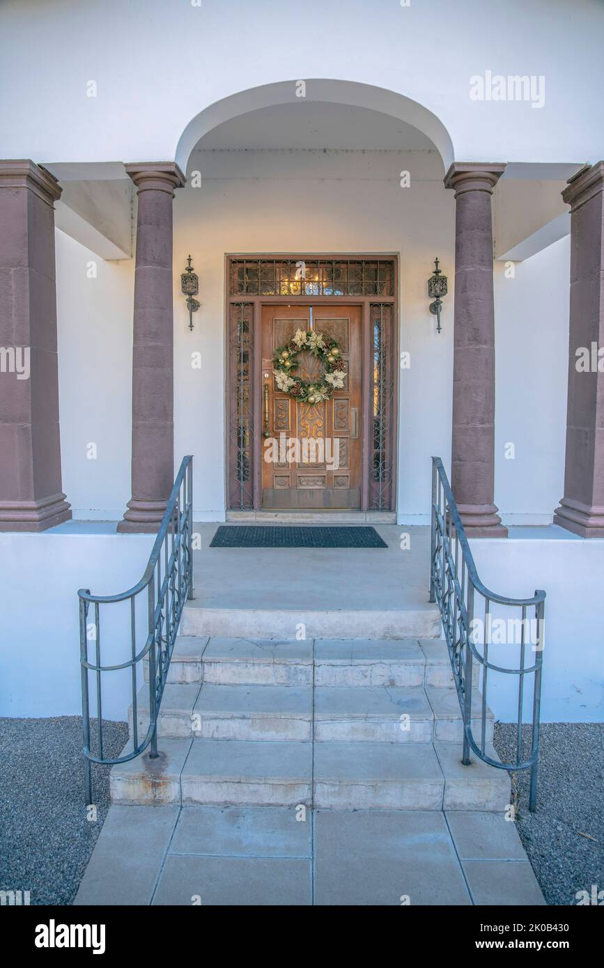 Downtown Tucson, AZ- Large carved wooden door with wreath and railings ...