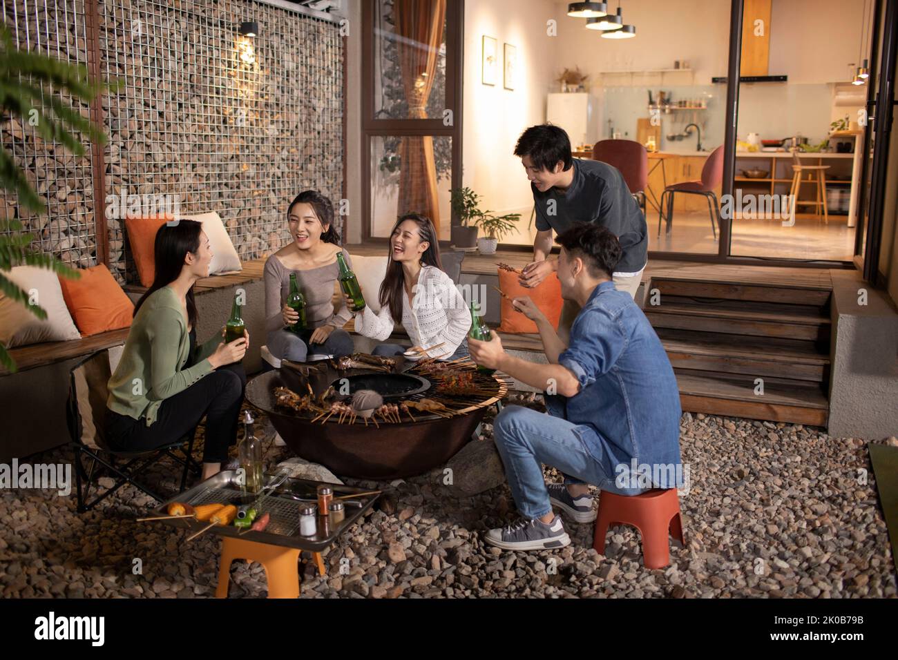 Happy young chinese friends barbecuing hi-res stock photography and ...