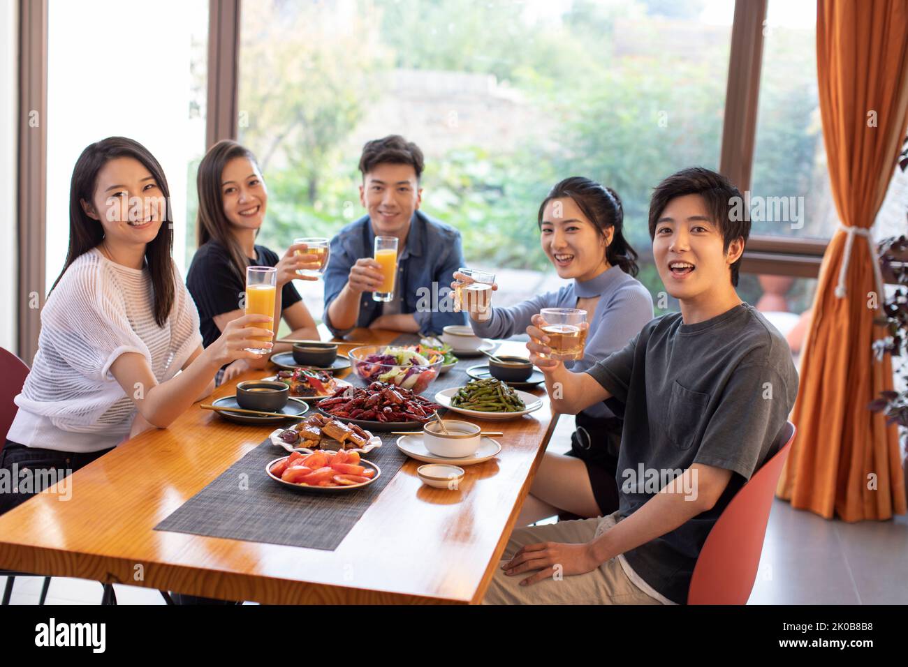 Cheerful adult friends dining hi-res stock photography and images - Alamy