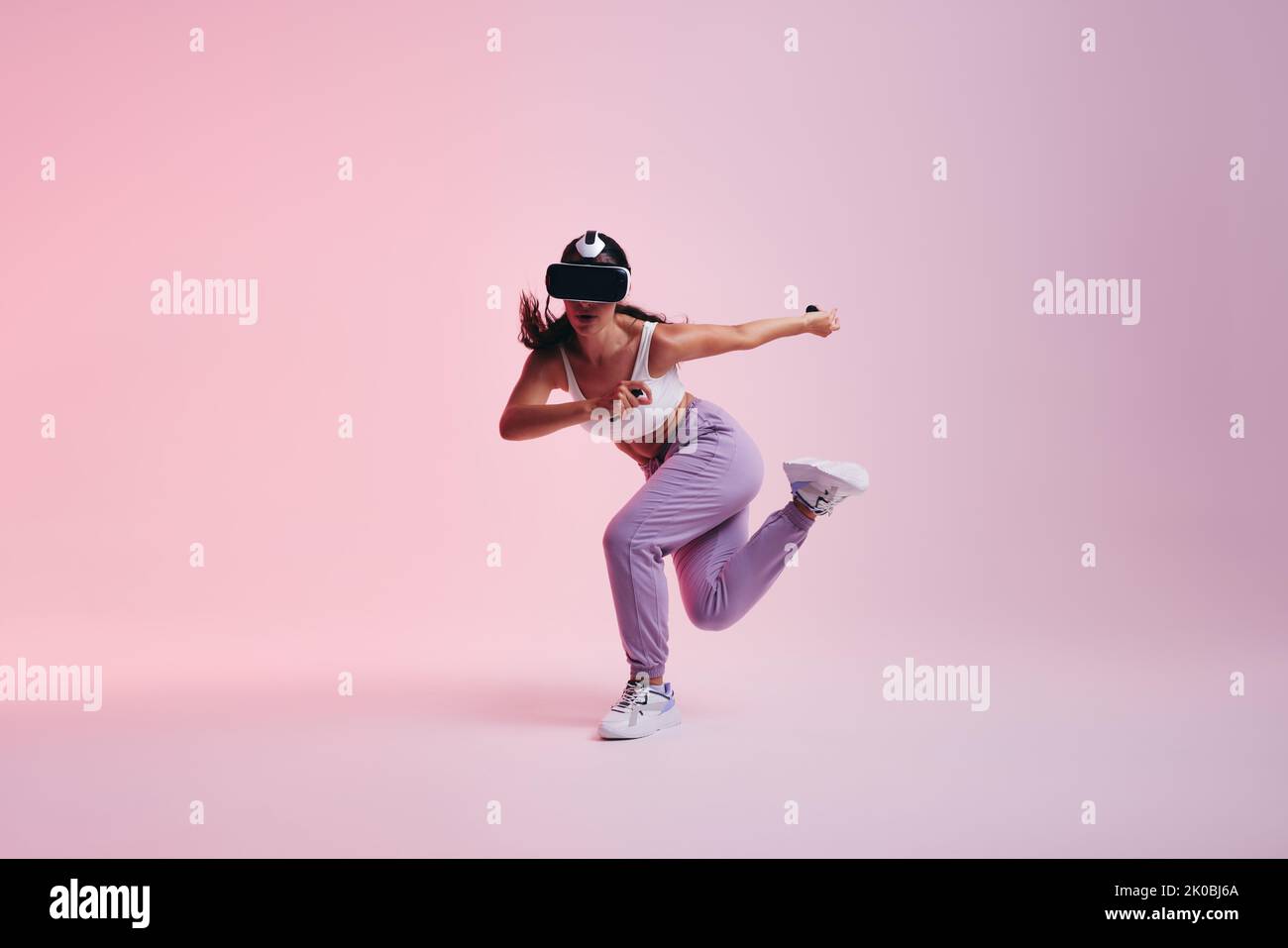 Gaming in the metaverse. Active young woman exploring an immersive ...