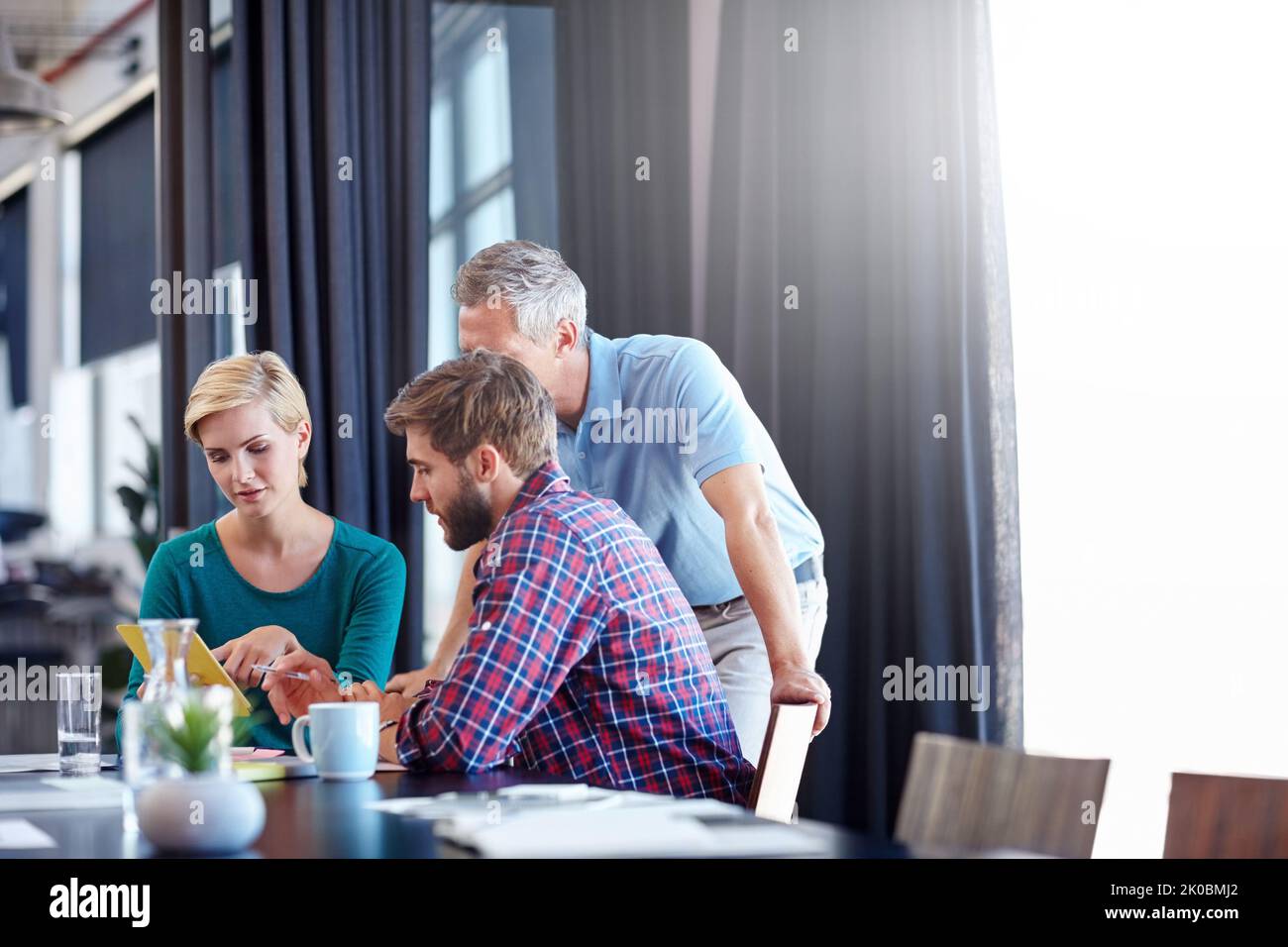 Making it happen. a group of colleagues having a discussion over a ...