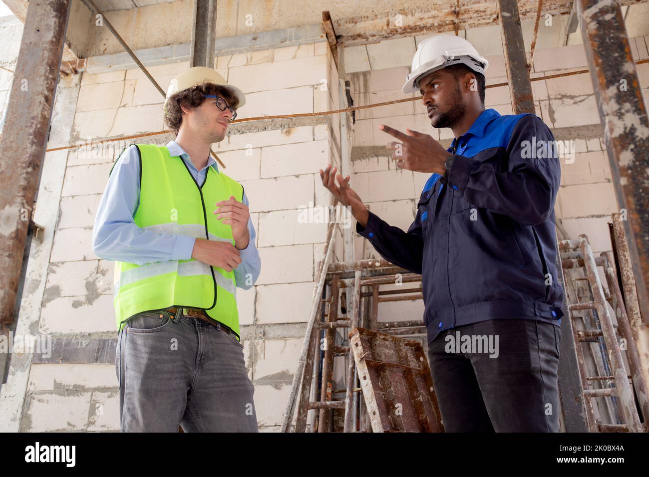 Architect and builder talking and inspector construction at ...