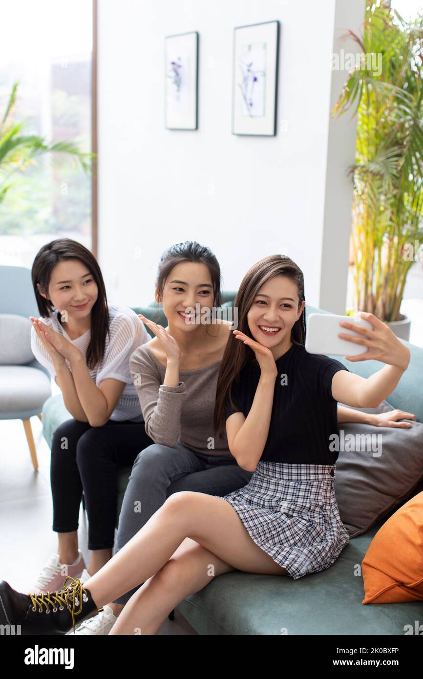 Happy young Chinese friends taking selfie at home Stock Photo - Alamy