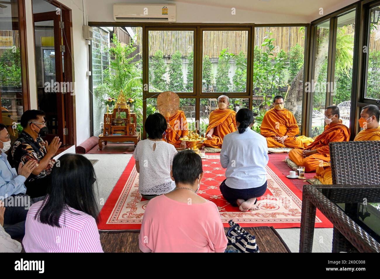 Devotees offering prayers during the blessing ceremony. Thai Buddhist ...