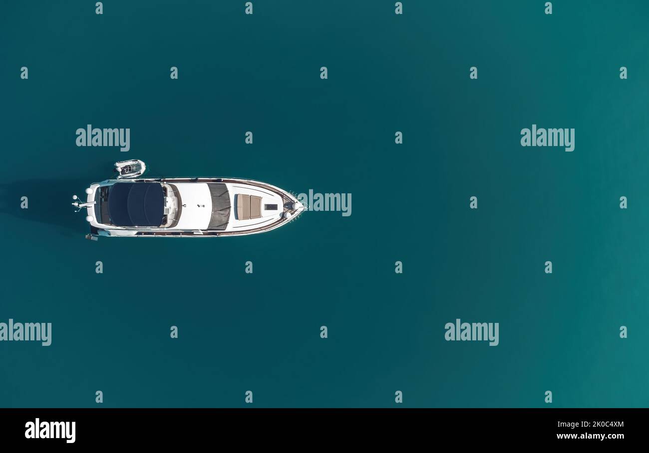 Aerial yacht on calm sea. Luxury cruise trip. View from above of white ...