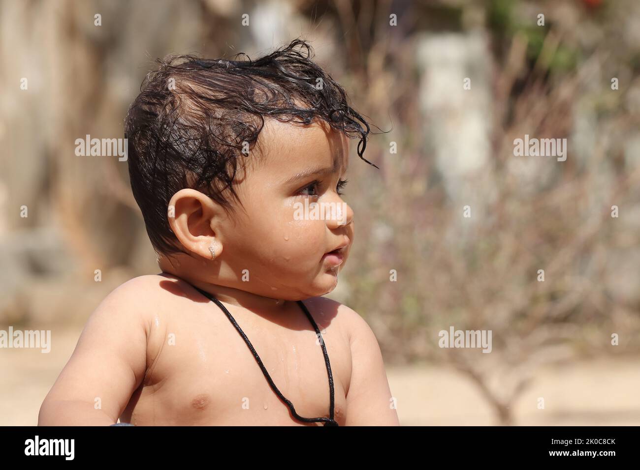 Close-up photo side view of beautiful happy baby boy with smiling faces ...