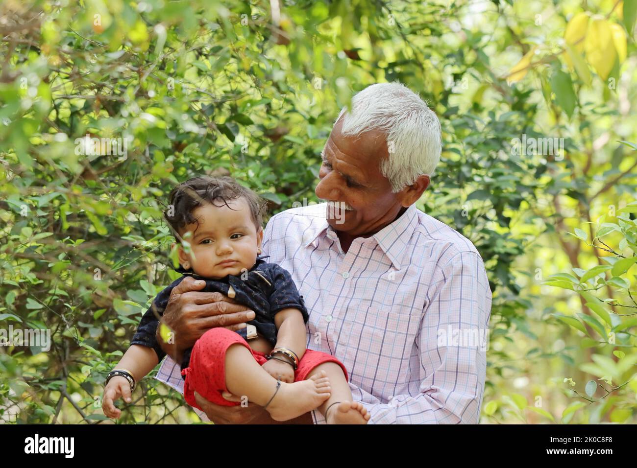 Portrait photo of Indian Senior grandfather with toddler grandson ...