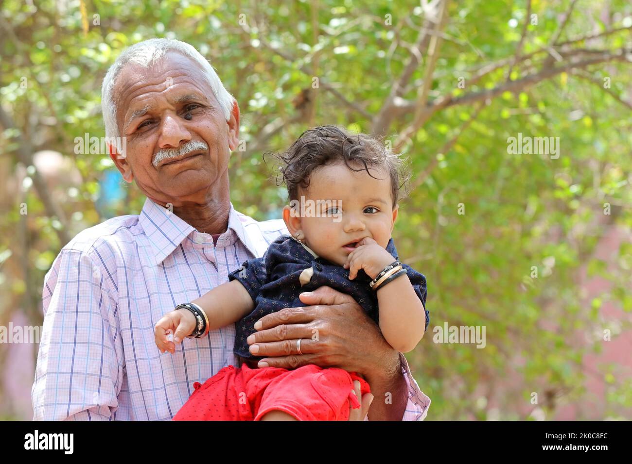Portrait photo of Indian Senior grandfather with toddler grandson ...