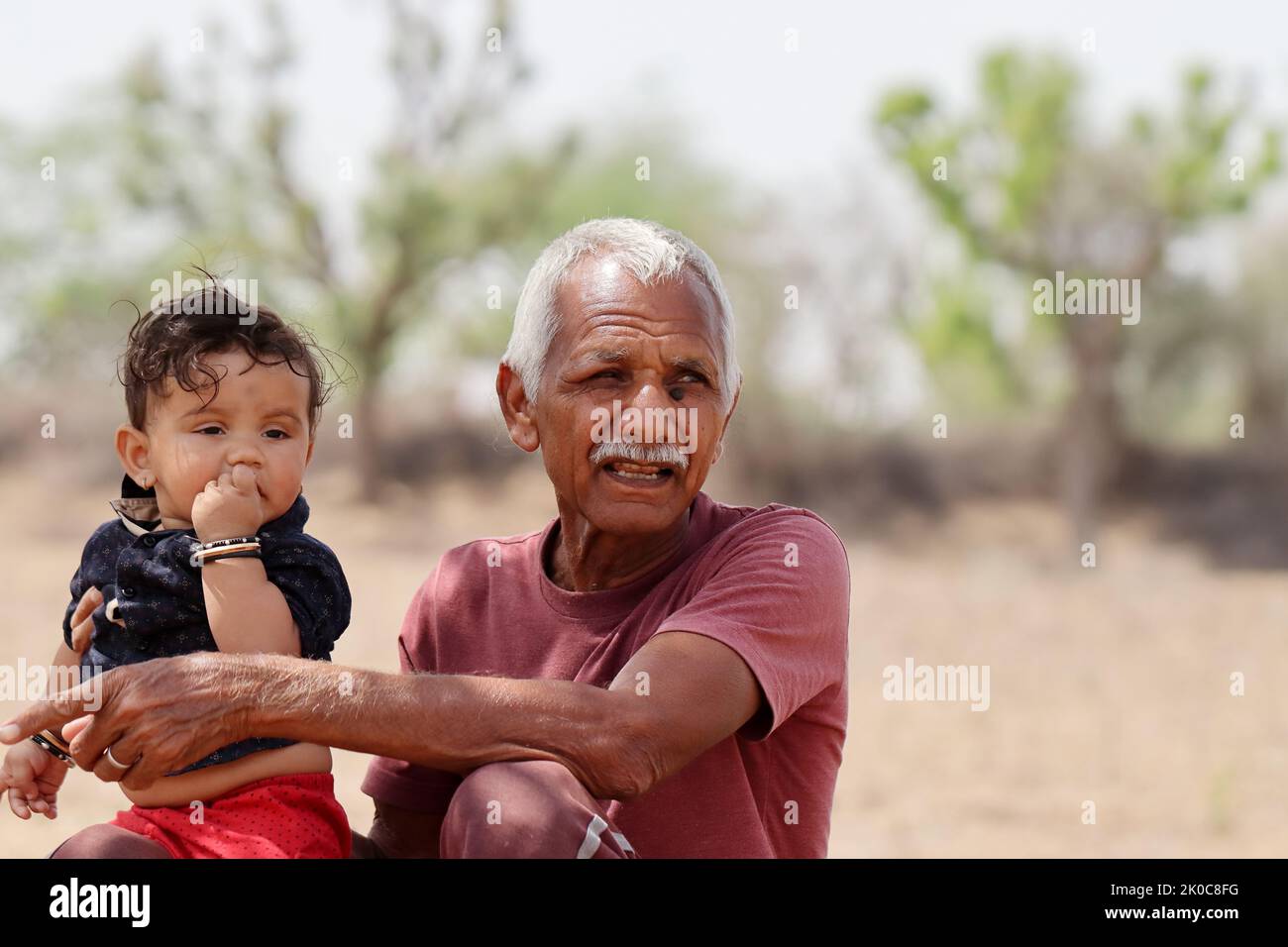 Portrait photo of Indian Senior grandfather with toddler grandson ...