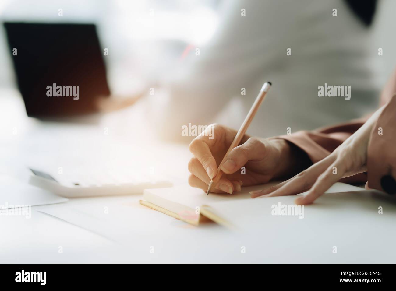 Asian Business Woman or Accountant do math and analyze with calculator ...