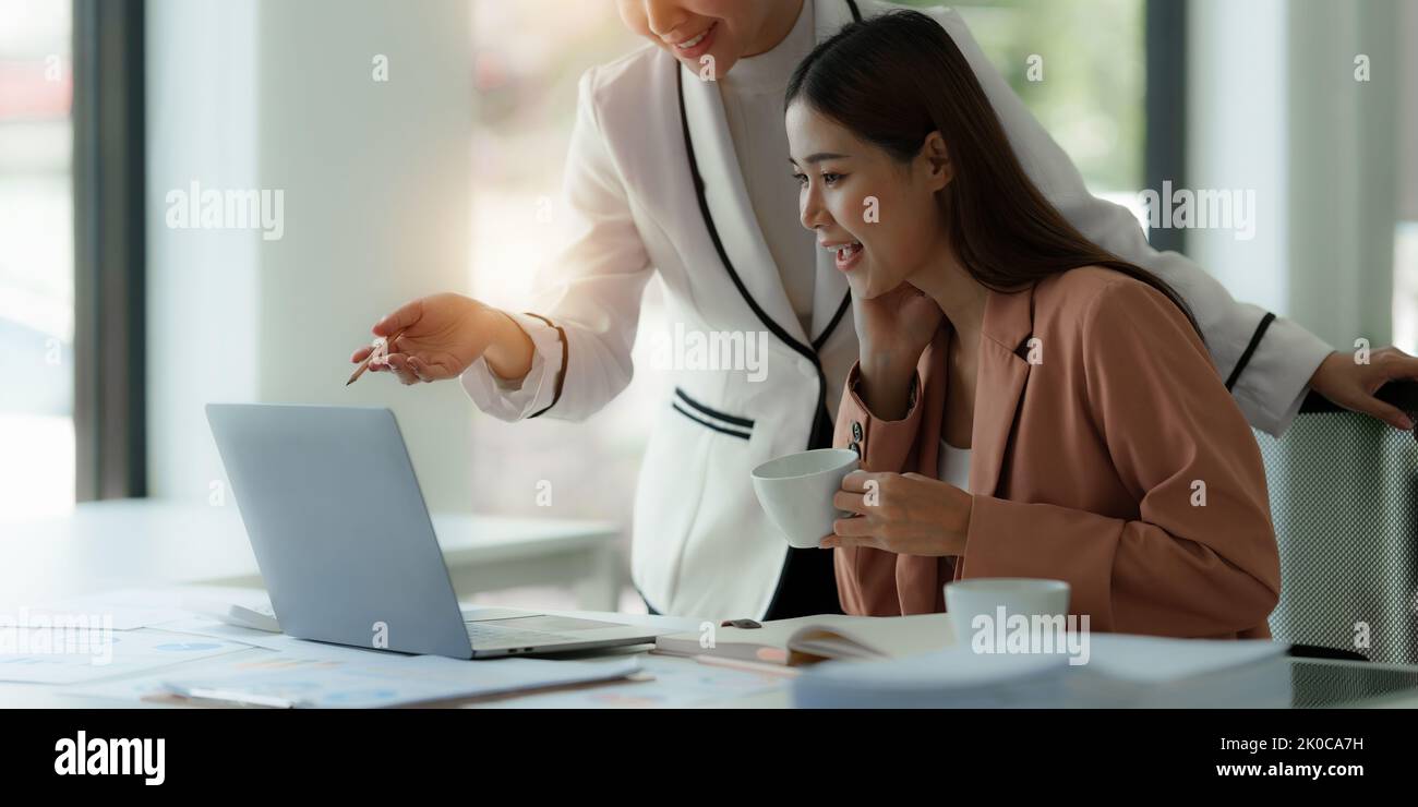 Asian Business Woman or Accountant do math and analyze with calculator ...