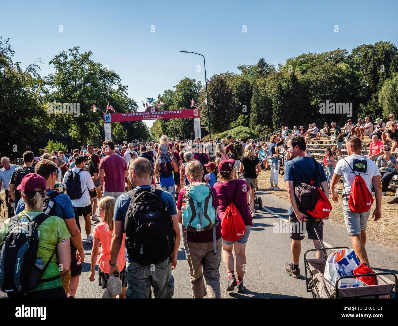 Groups of families are seen arriving at the finish line on a very warm ...