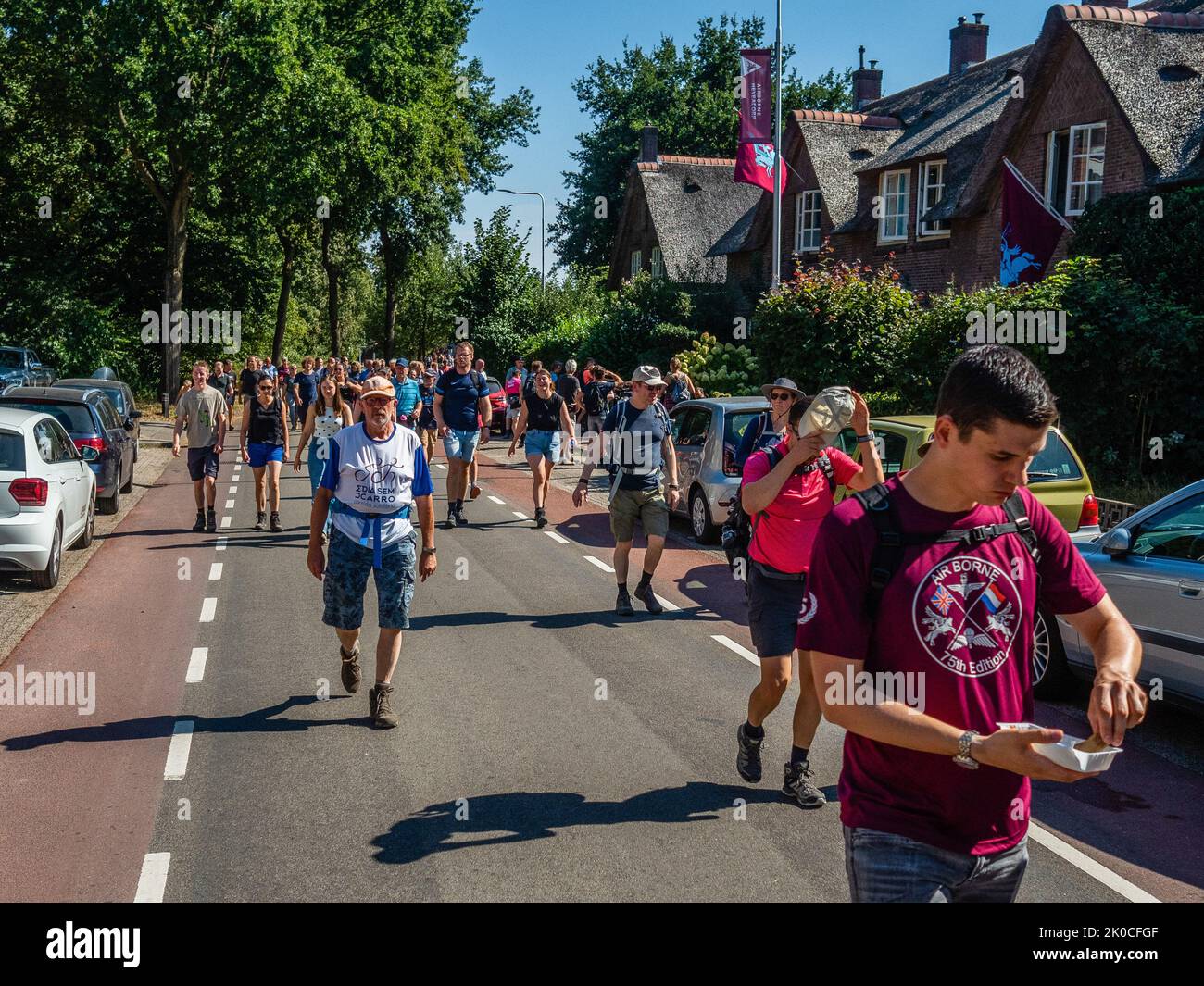 One of the participants is seen eating while walking on a very warm day ...