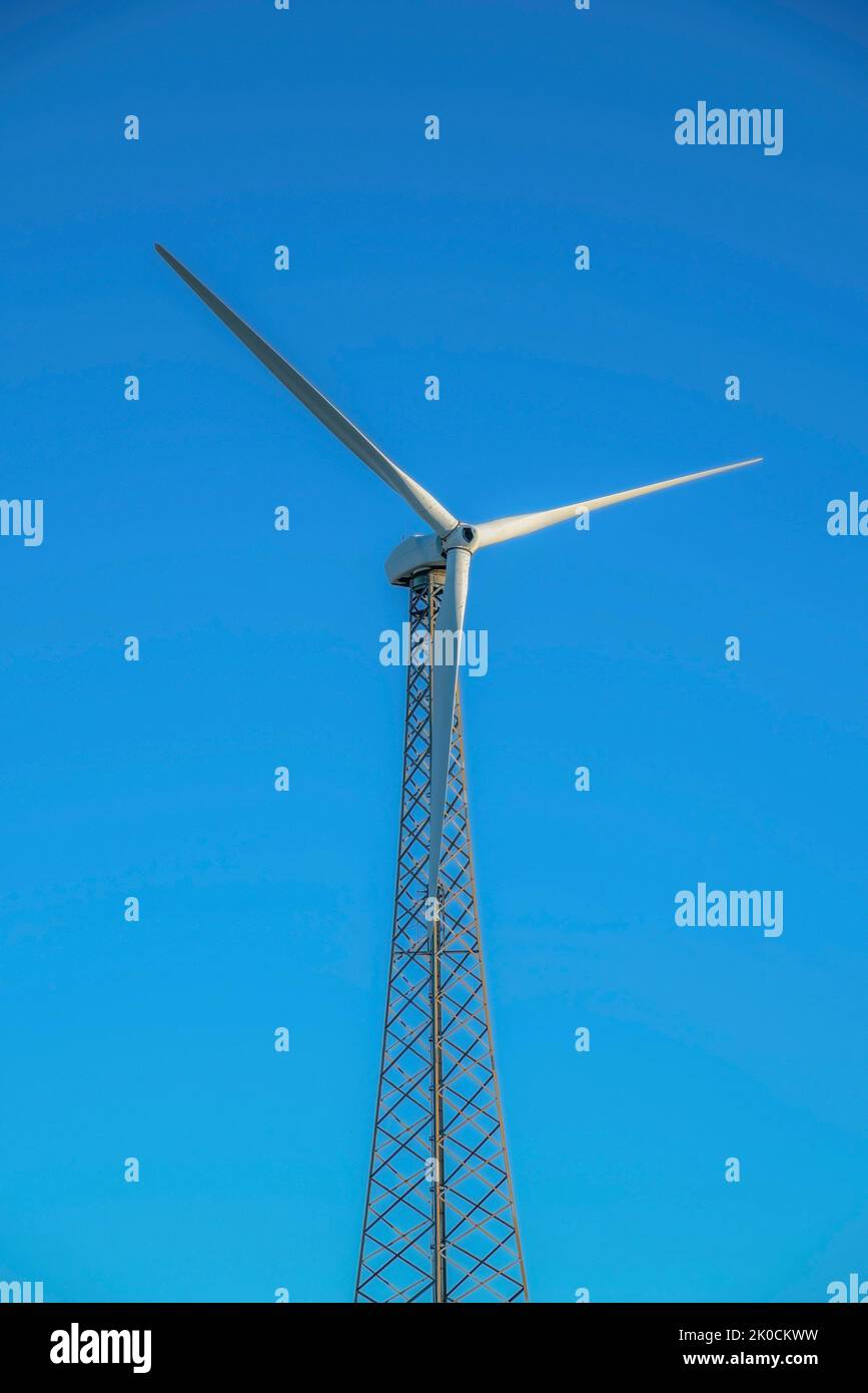 Low angle view of a windmill with lattice tower in a desert at ...
