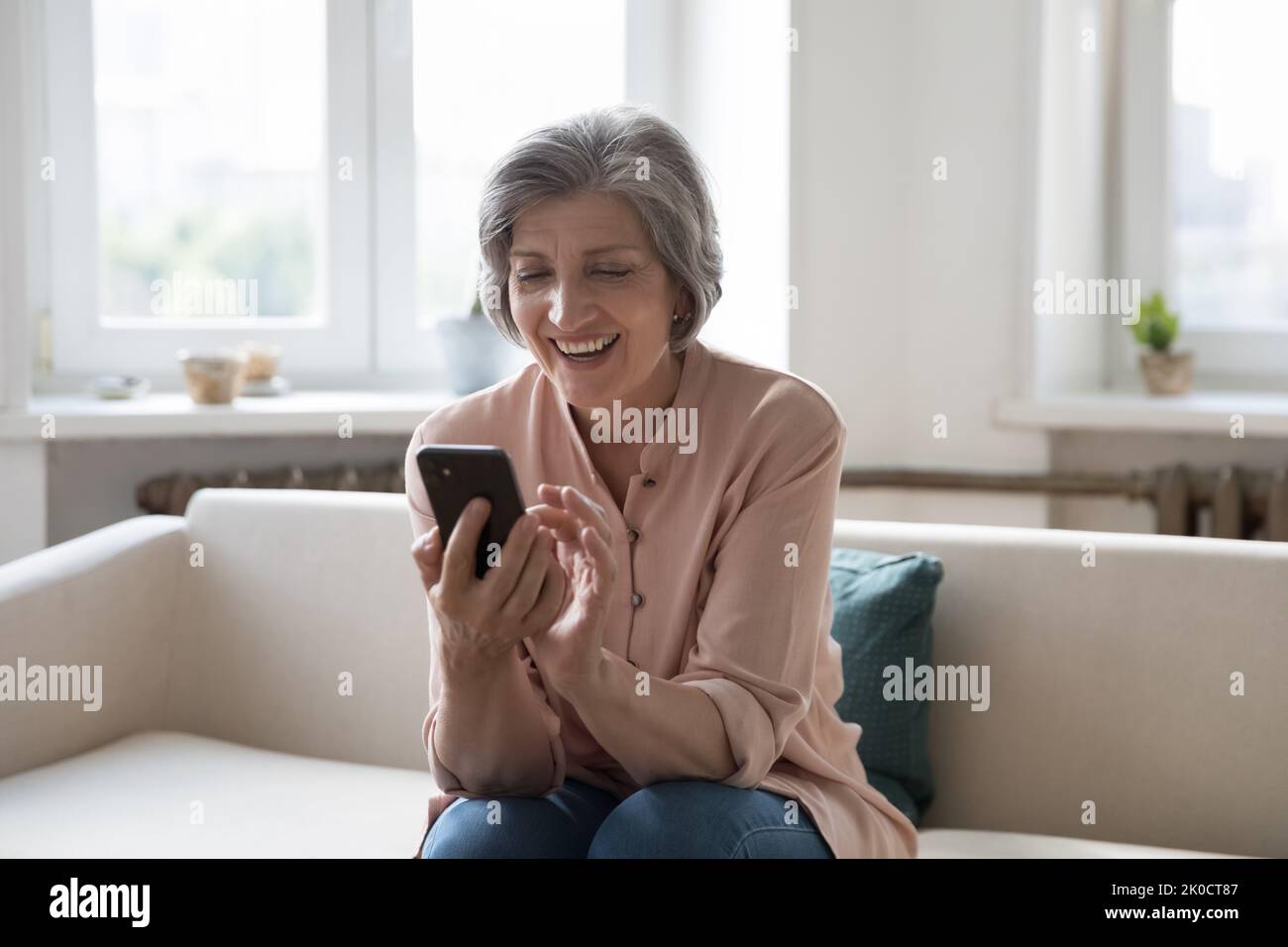 Cheerful older grandma woman talking on video call Stock Photo - Alamy
