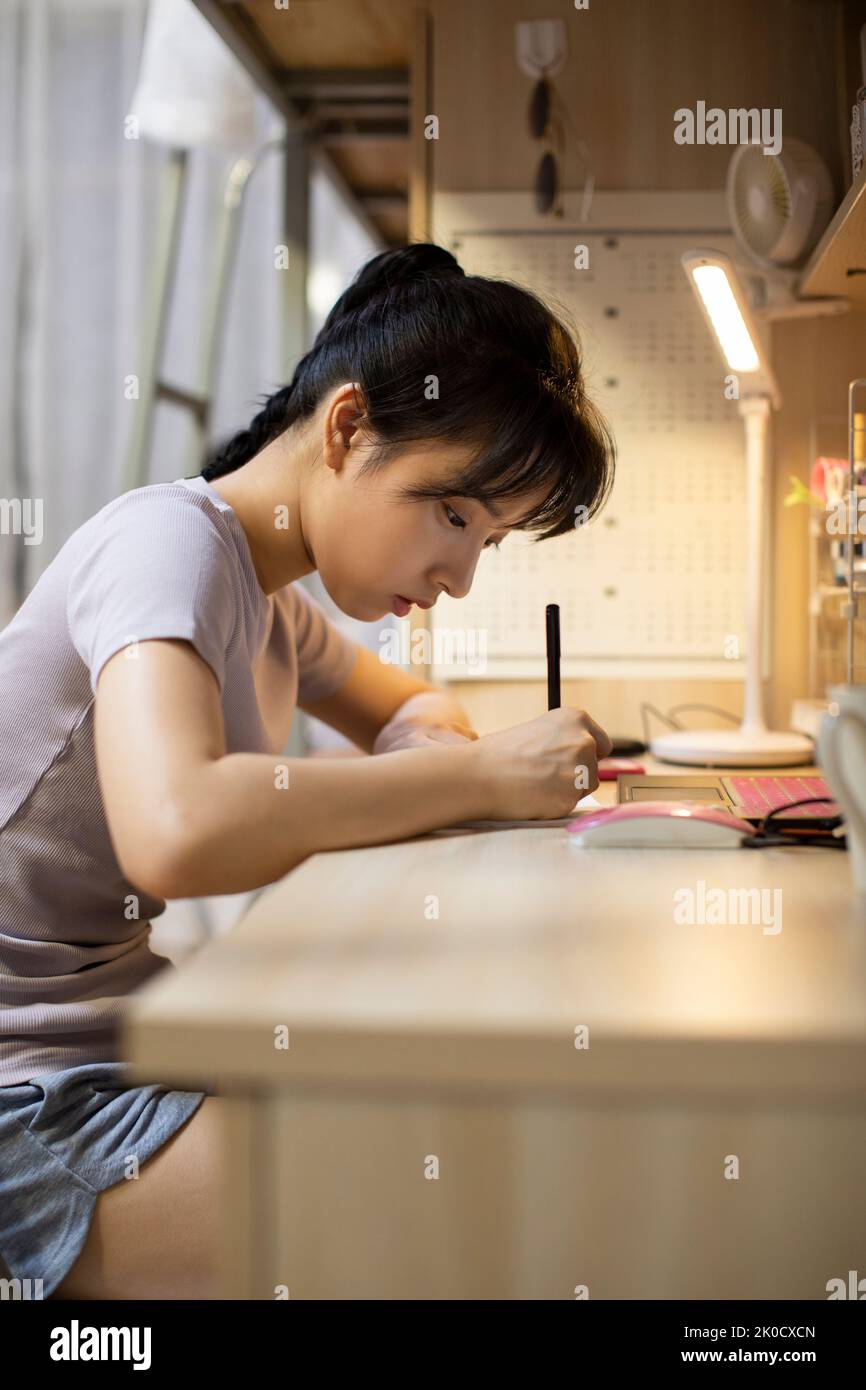 Young Chinese university student learning in dormitory Stock Photo - Alamy