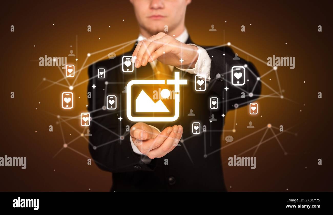 Hand holding social media icons Stock Photo - Alamy