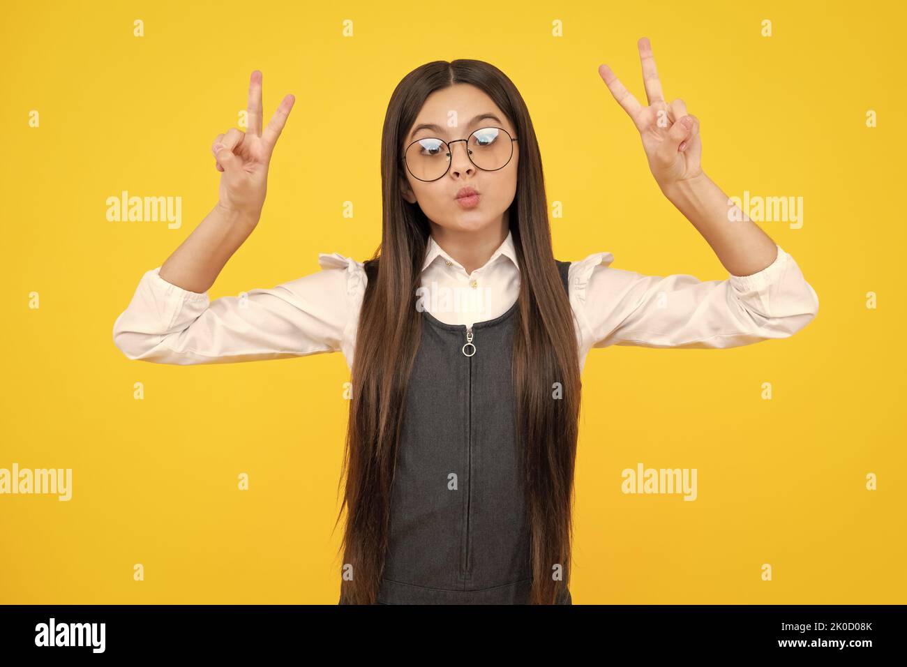 Funny face. Teenager child girl showing fingers victory sign. Number ...