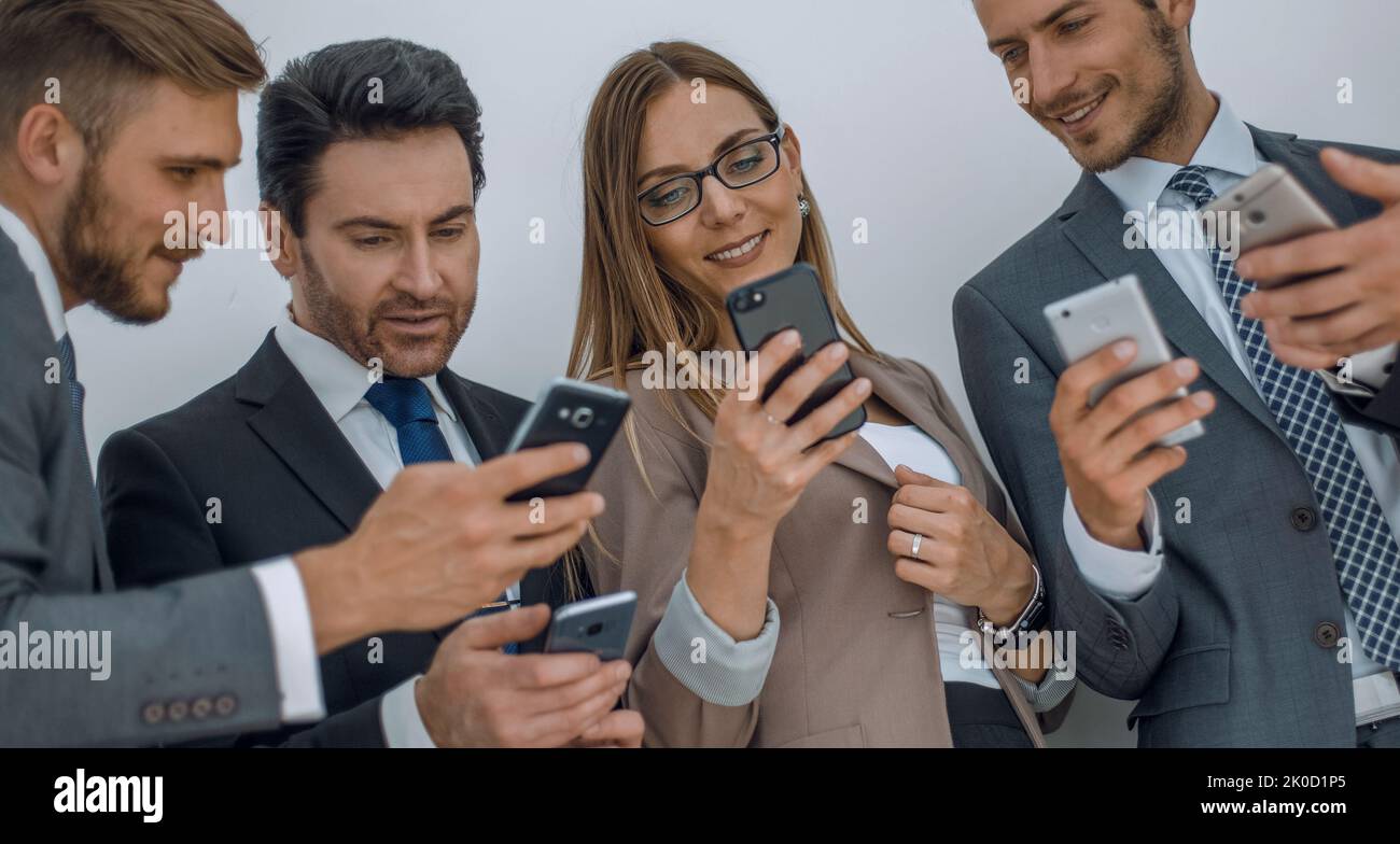group of business people reading a message on phones Stock Photo - Alamy