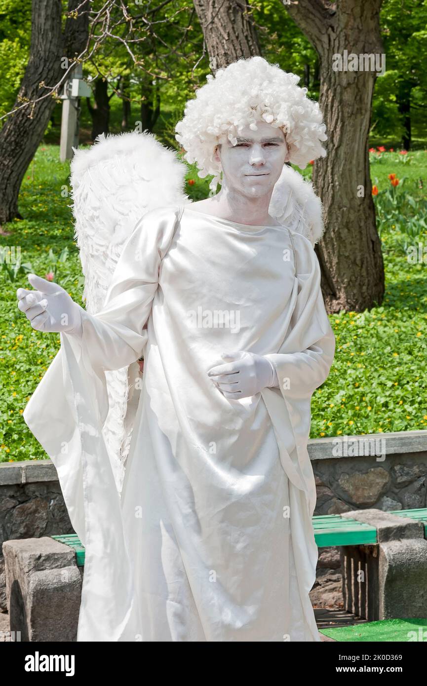 An unidentified busking mime in the image of angel performing on ...