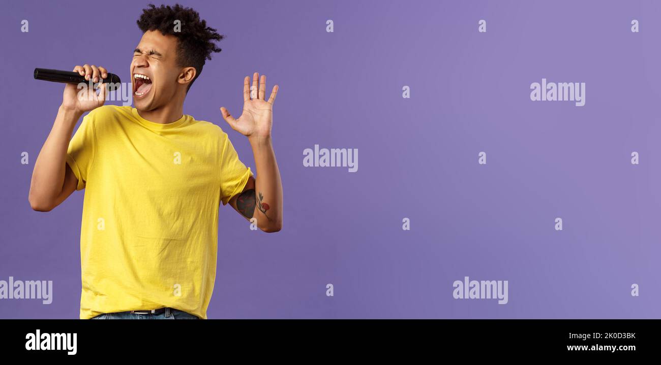 Portrait of passionate carefree young hispanic singer with dreads and ...