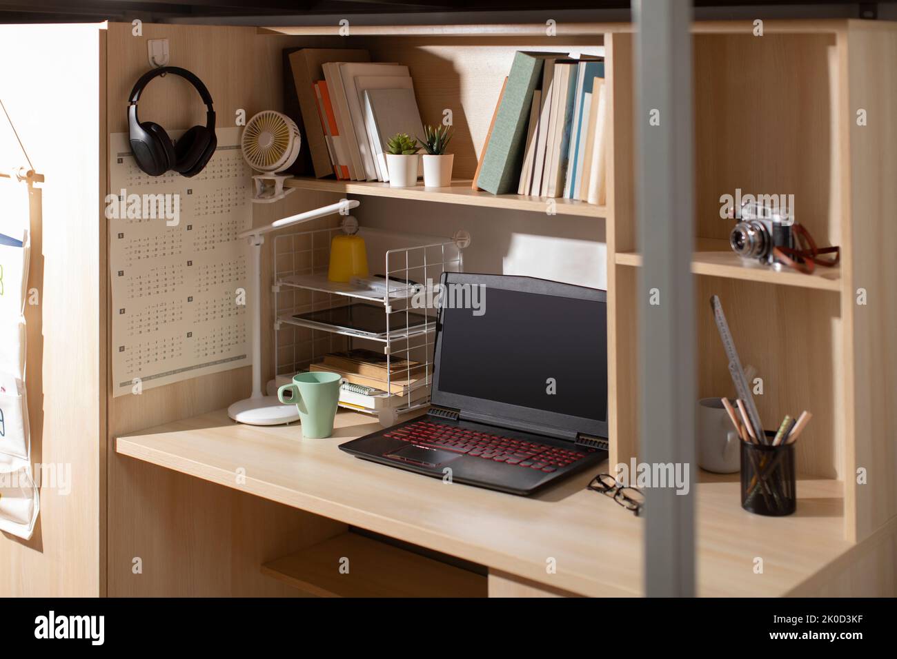 Books and laptop on desk Stock Photo - Alamy