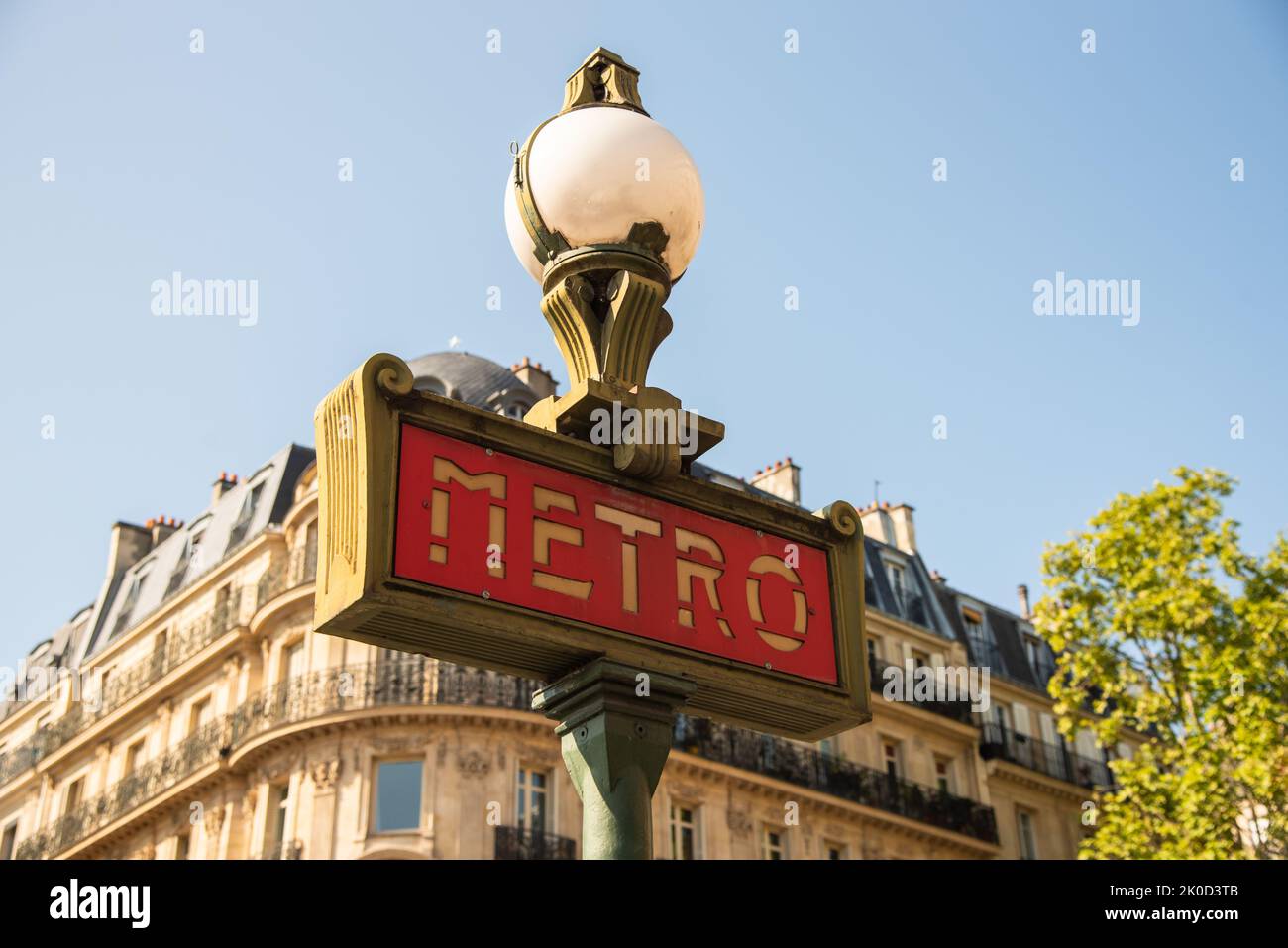 Paris, France. August 2022. Traditional Paris metro sign with buildings ...