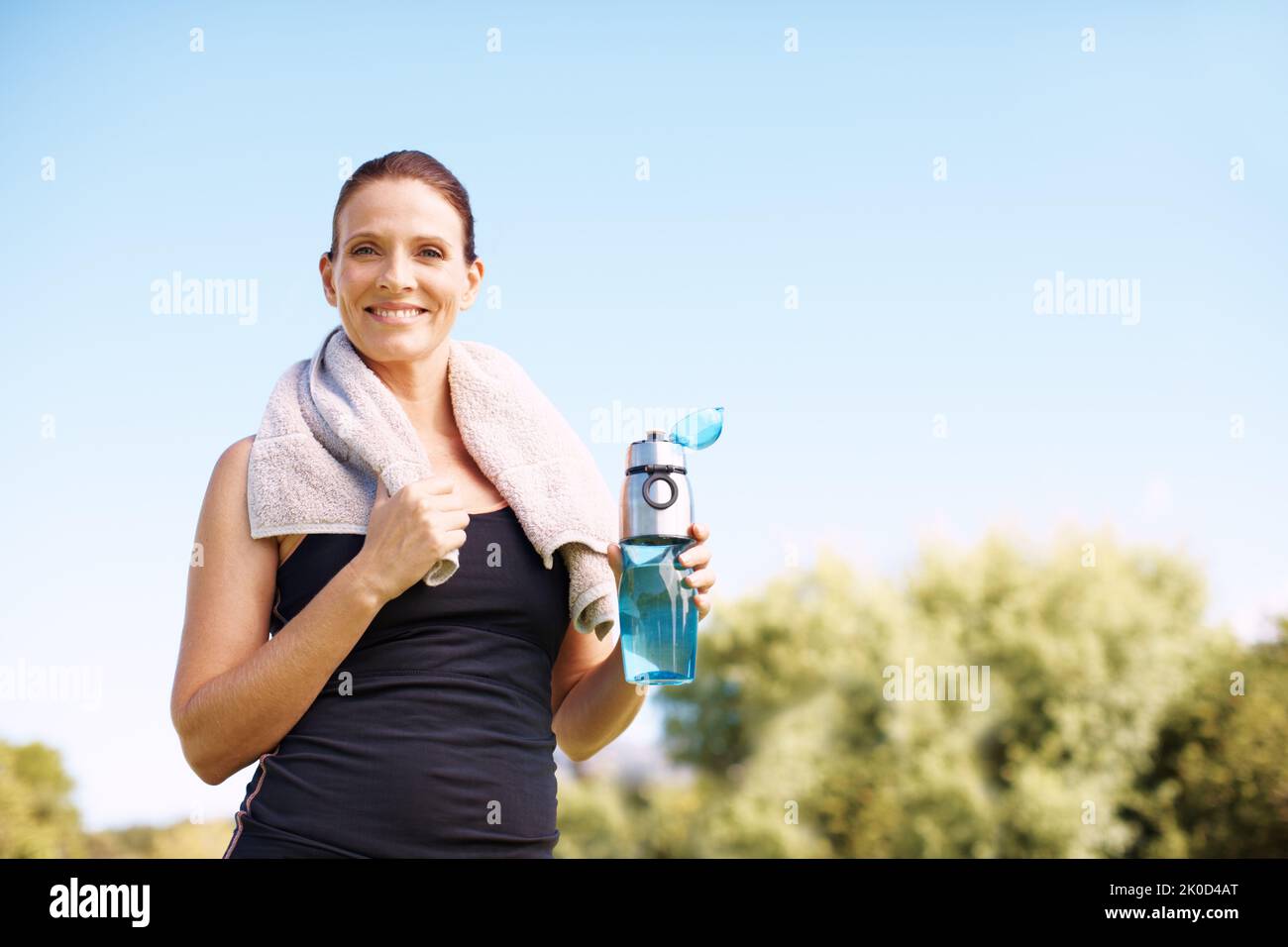 Outdoor workouts are the best. An attractive woman standing with her ...