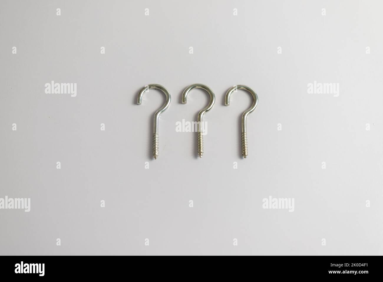 Question mark of screws on isolated white background or conceptual sign ...