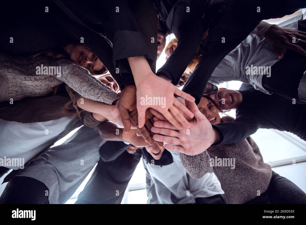 bottom view. group of happy young people making a tower out of their ...