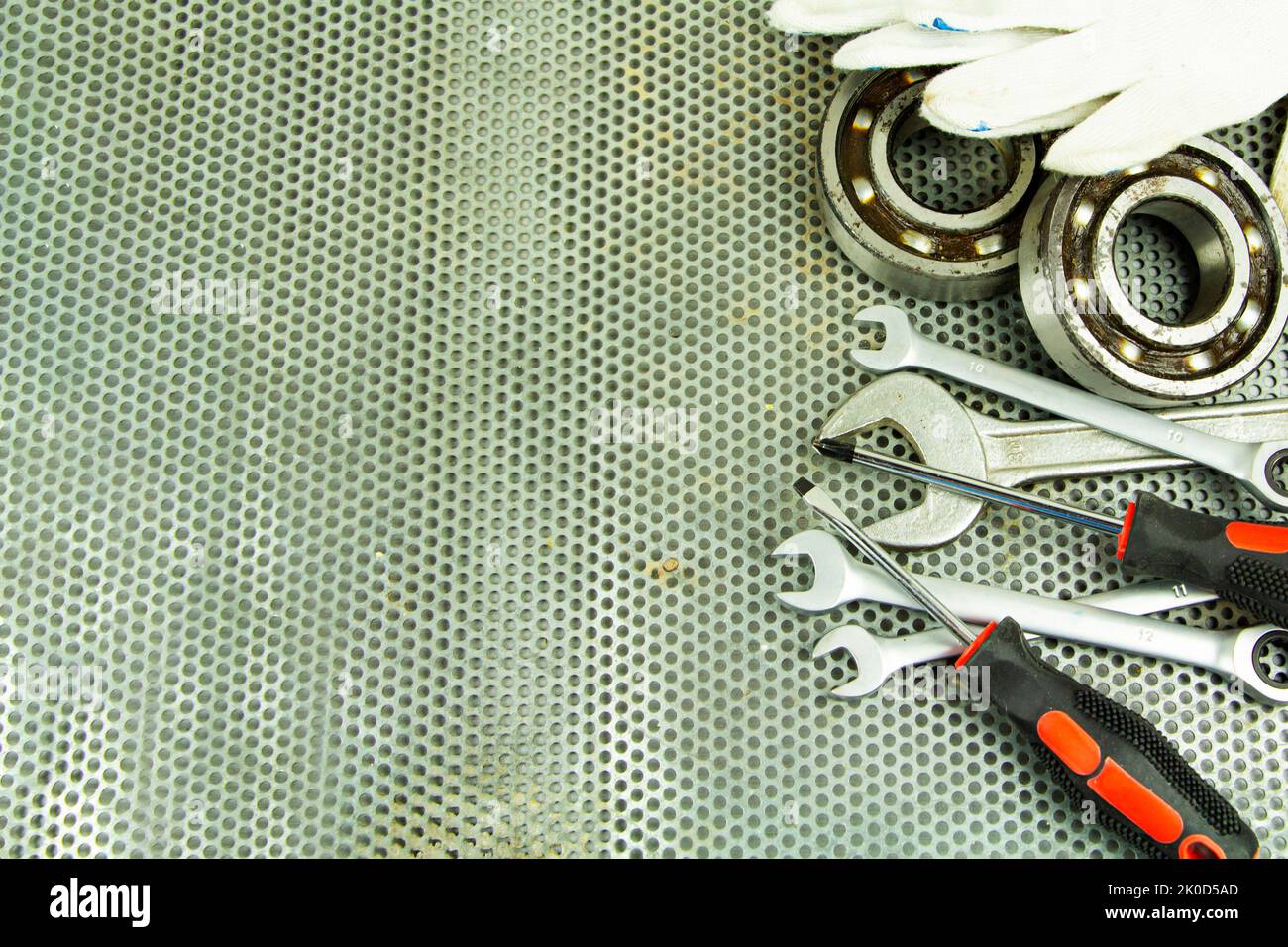 Metalworking tools, steel parts, a wrench, on the background of a metal ...