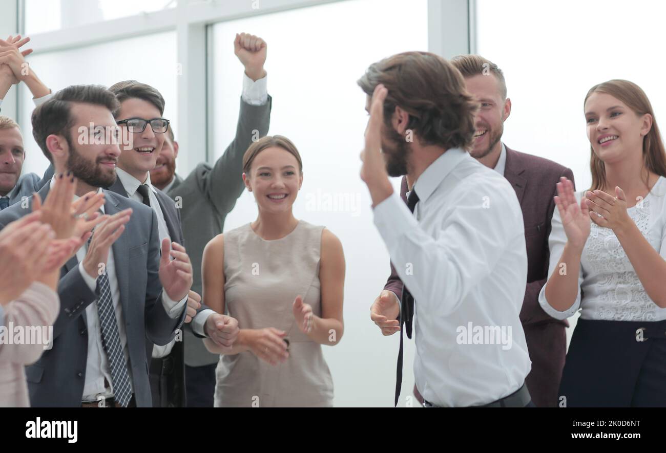 corporate group of employees congratulating each other on the victory ...