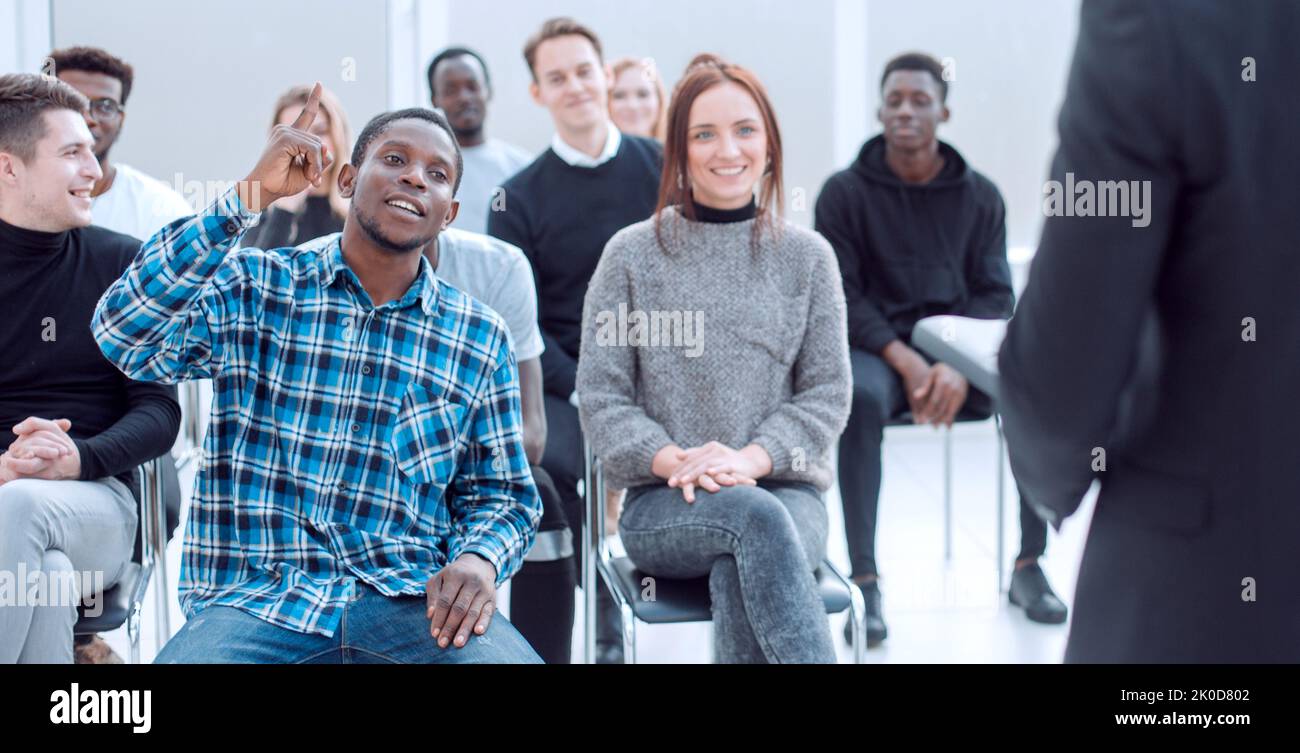 speaker and a group of diverse young listeners in a conference room ...