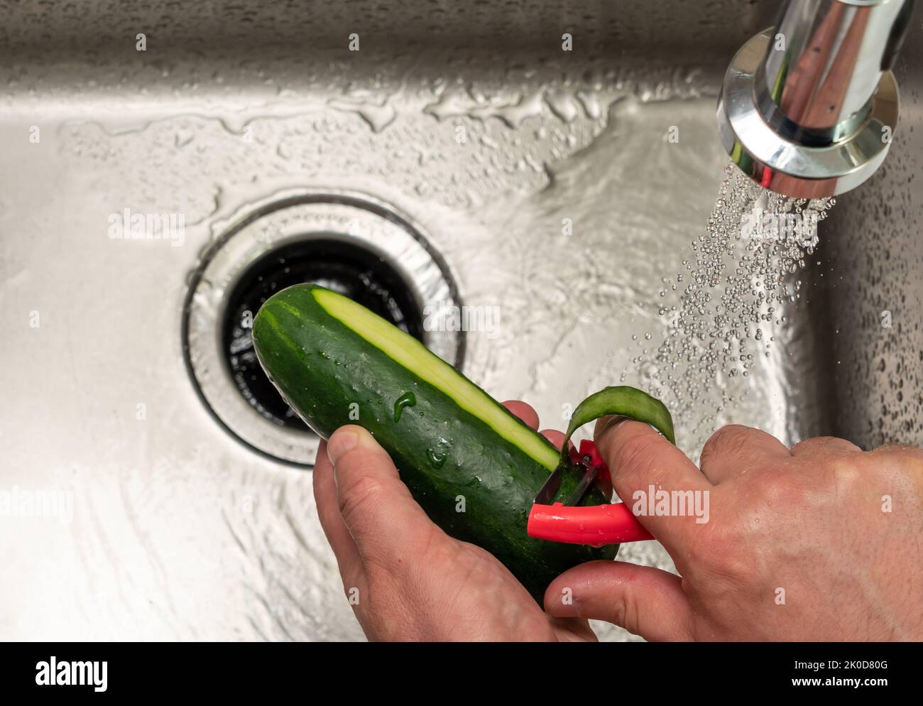 Washing fresh cucumber under running hi-res stock photography and ...