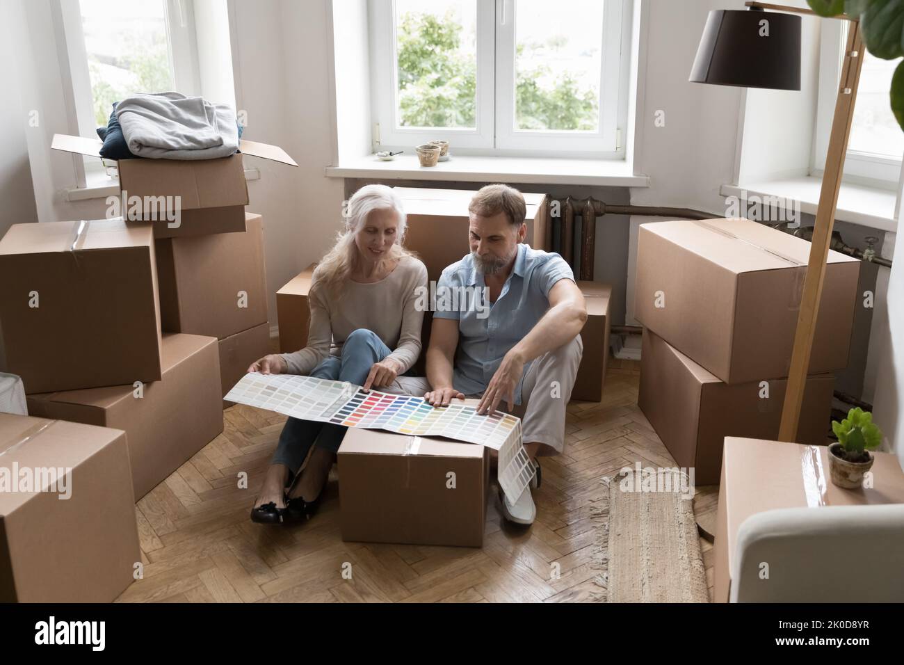 Elderly grey haired couple choosing colors for new home interior Stock ...