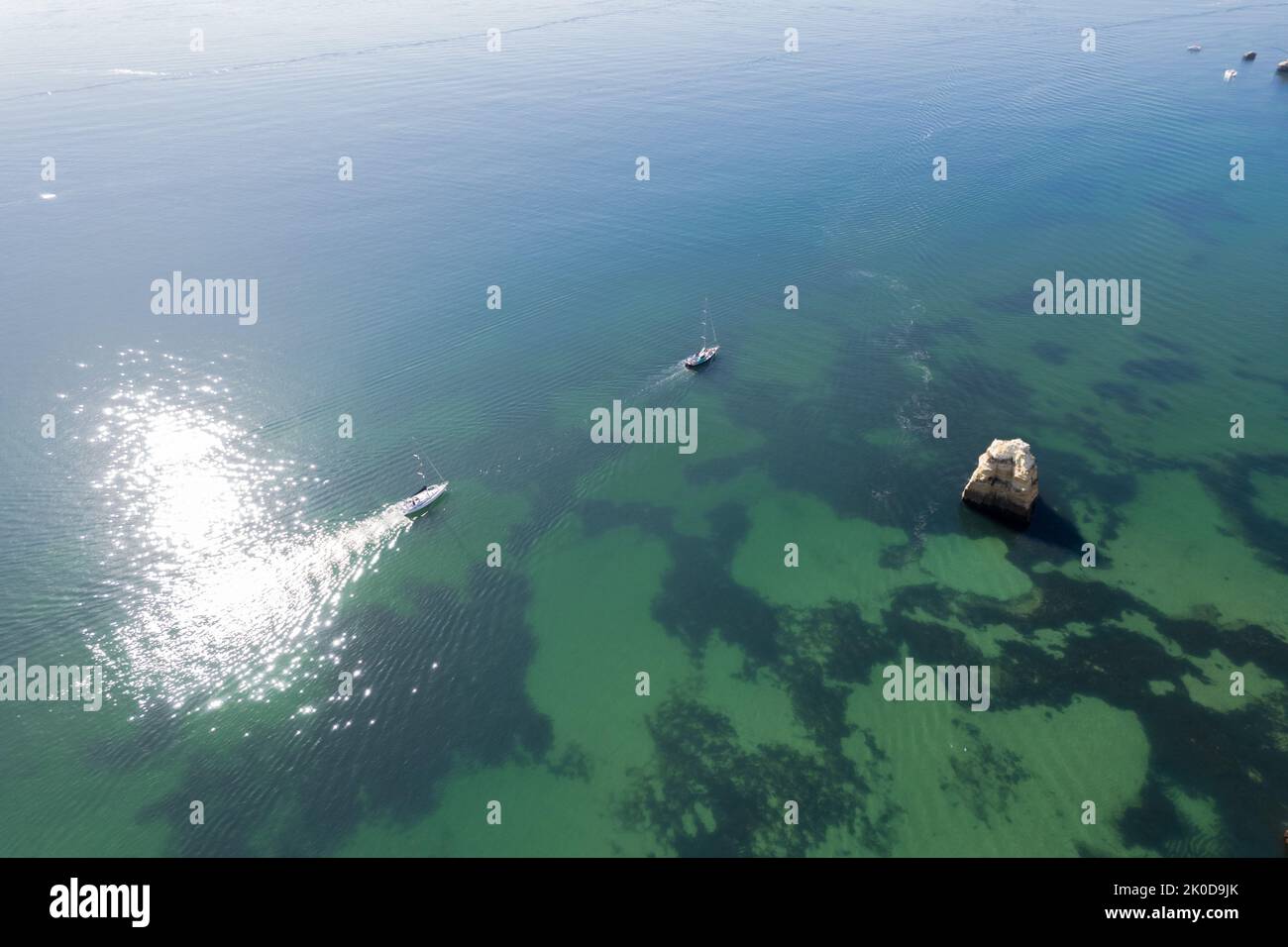 Aerial drone photo of small luxury yacht with wooden deck cruising near ...