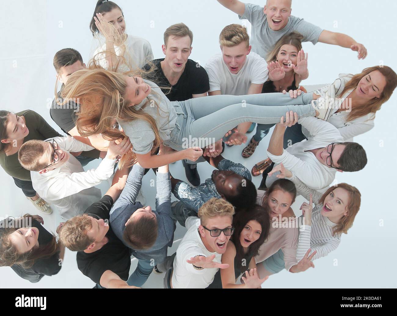 happy team of young people rocking their leader Stock Photo - Alamy