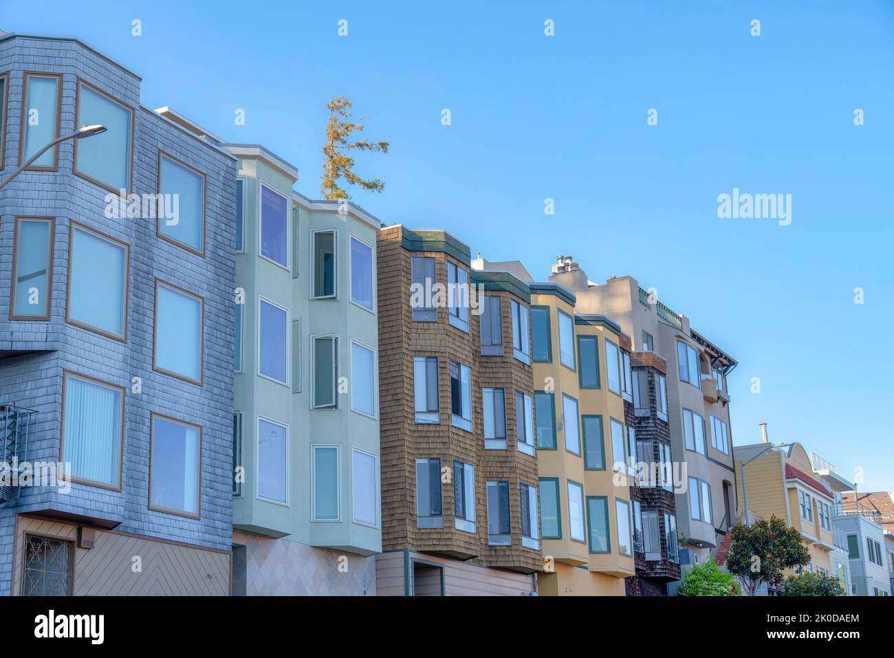 Small apartment buildings with different wall sidings and window ...