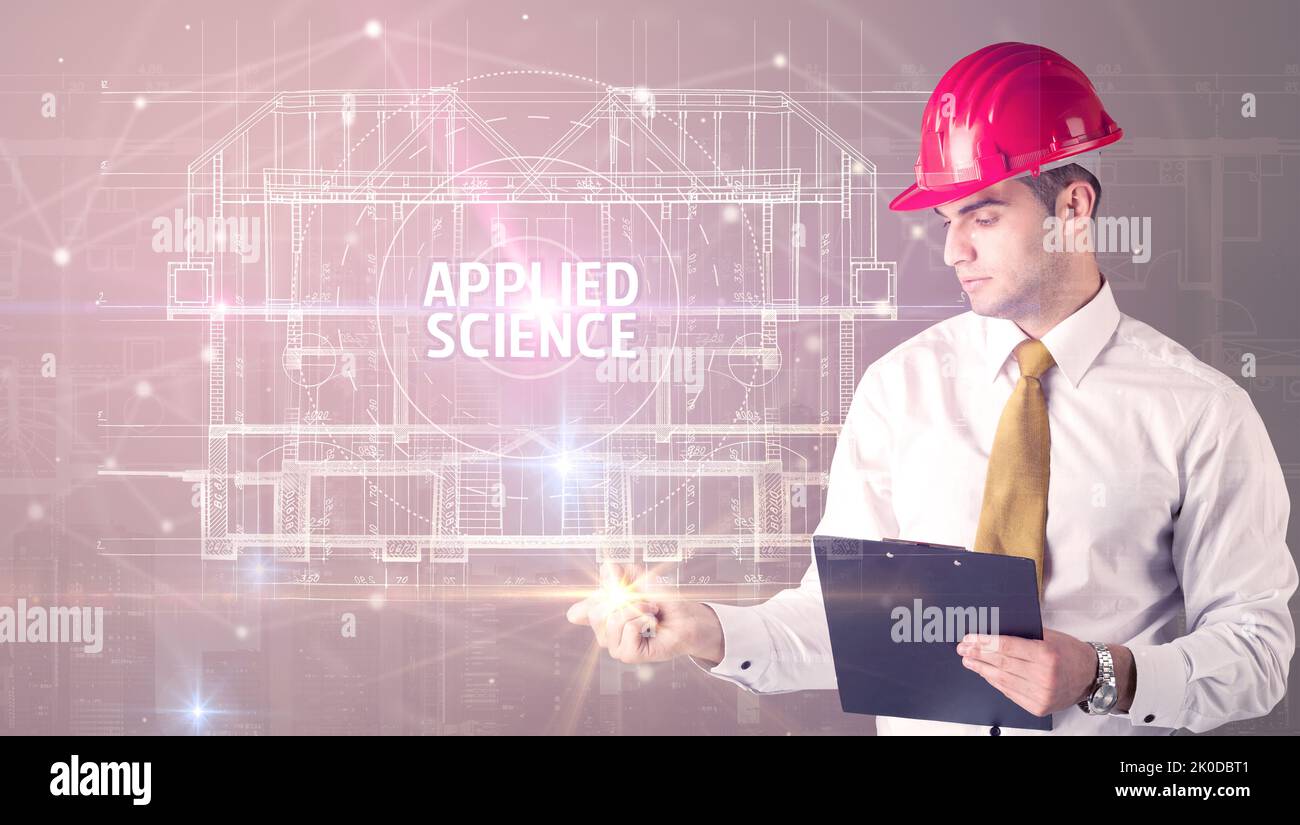 Handsome architect drawing with helmet Stock Photo - Alamy