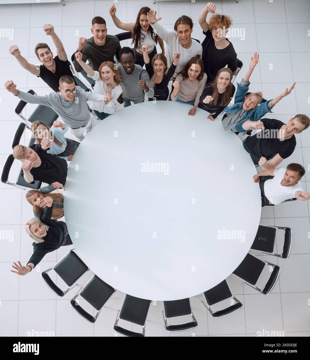 top view. group of young people standing near a large round table Stock ...